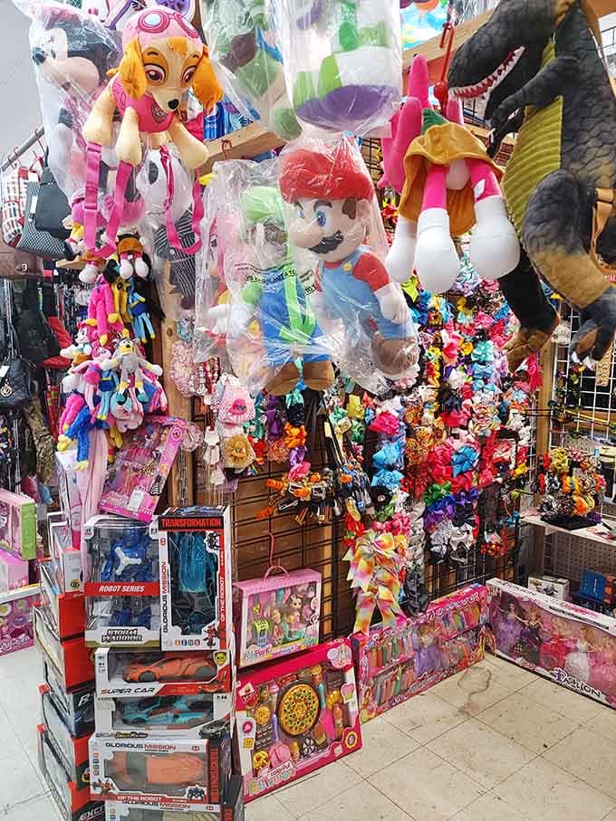 Giant plush characters tower overhead like friendly giants guarding a kingdom of childhood dreams and nostalgic memories below.