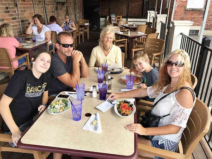 Happy diners enjoying their meals on the patio, living their best small-town Italian restaurant life.
