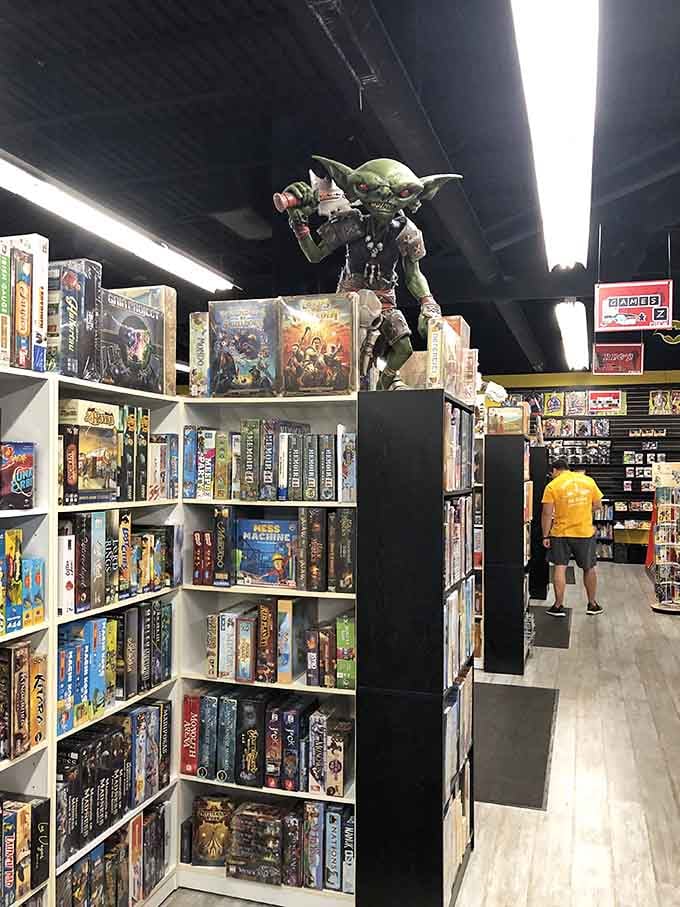 Baby Yoda perched atop the shelves watches over shoppers with the wisdom of someone who's seen it all before.