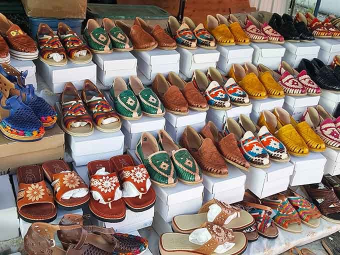 Handcrafted footwear in every color imaginable, displayed like edible art that happens to be perfectly wearable instead.