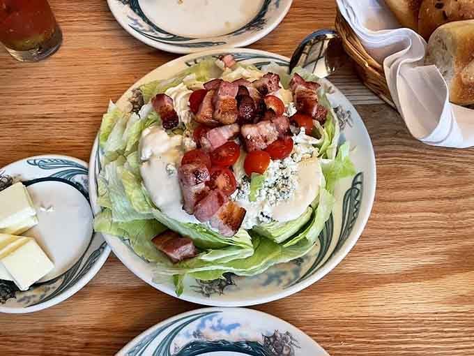Wedge salad topped with bacon and blue cheese, because vegetables deserve the steakhouse treatment too.