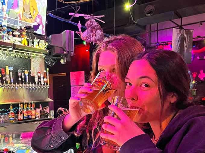 Friends raising glasses in a toast to good times, great games, and the joy of never growing up.