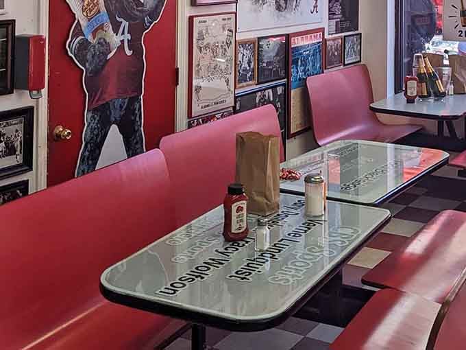 Red booths facing walls of championship memories, where every meal comes with a side of legendary victories and nostalgic glory.