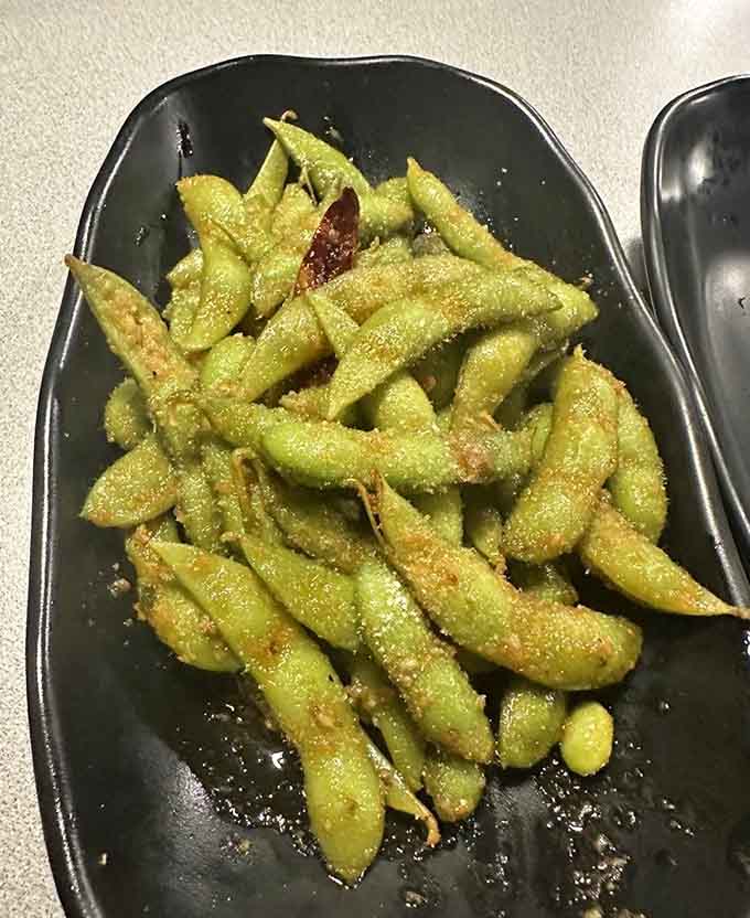 Spicy garlic edamame proves that even simple soybeans can become dangerously addictive when seasoned just right.