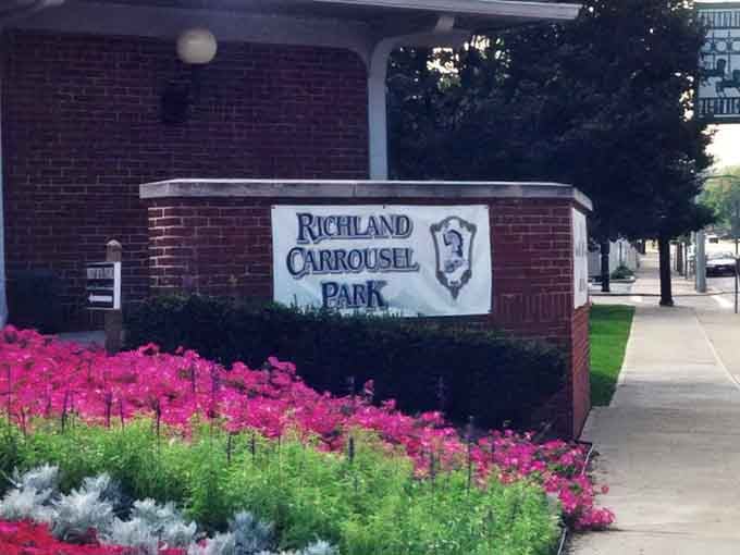 Flowers blooming around the entrance sign promise that inside, something even more vibrant than petunias awaits your discovery.