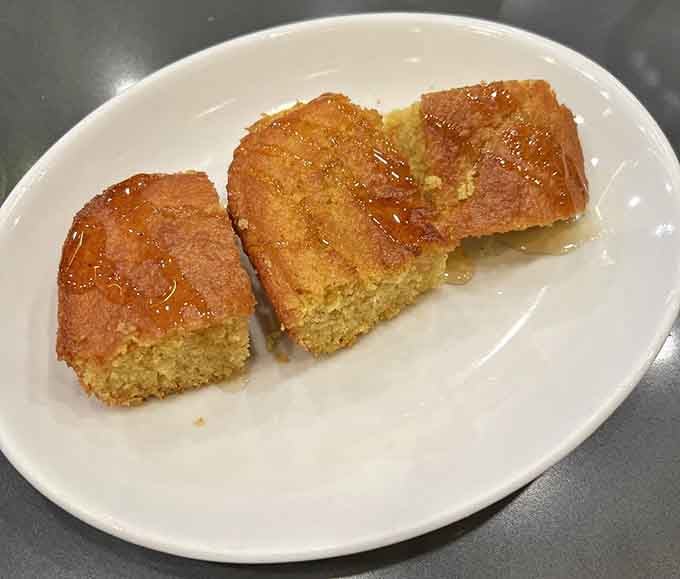 Three pieces of golden cornbread drizzled with honey prove simplicity often beats complexity in the flavor department.