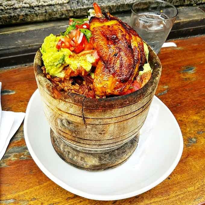 Pork served in a wooden barrel because sometimes presentation matters almost as much as the explosive flavors inside it.