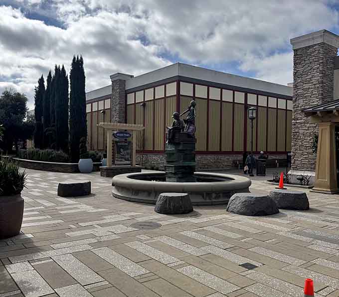 An outdoor plaza fountain providing ambiance and a convenient spot to rest feet that forgot what walking felt like.