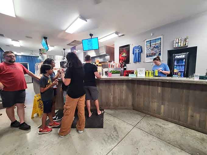 Inside, families line up for treats while screens display showtimes, creating the perfect pre-movie buzz and anticipation.