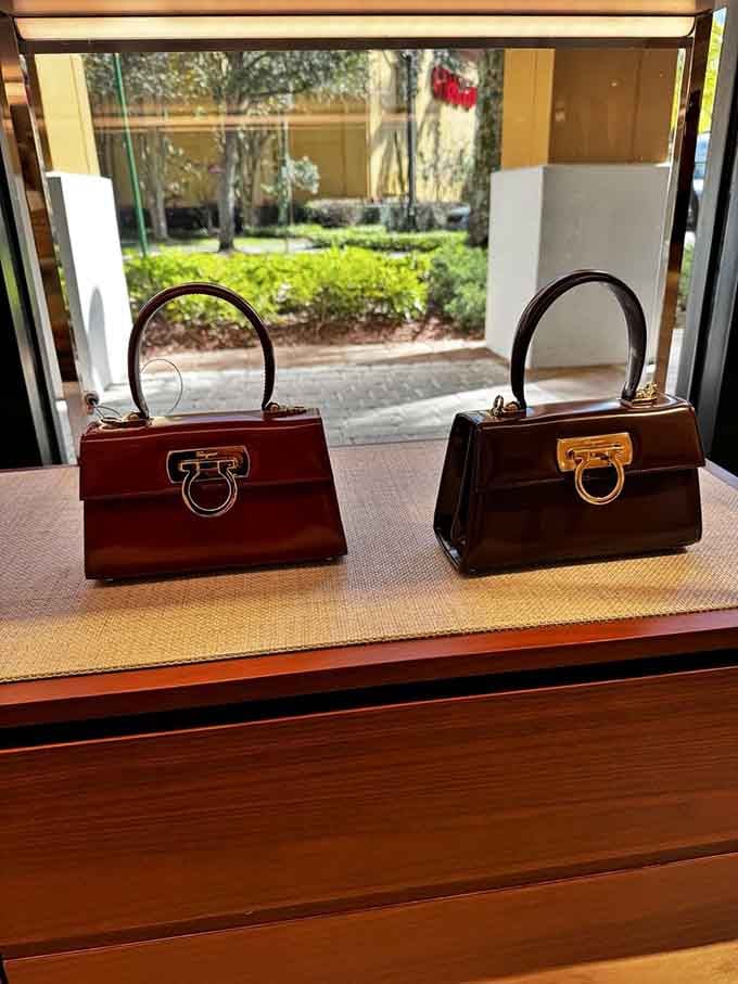 Elegant handbags perch in window displays, their rich leather gleaming like treasures waiting to be discovered and claimed.