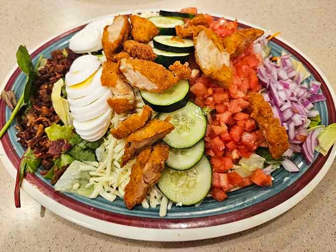 Fresh salad loaded with crispy chicken, hard-boiled eggs, and vegetables, proving they do more than just breakfast.