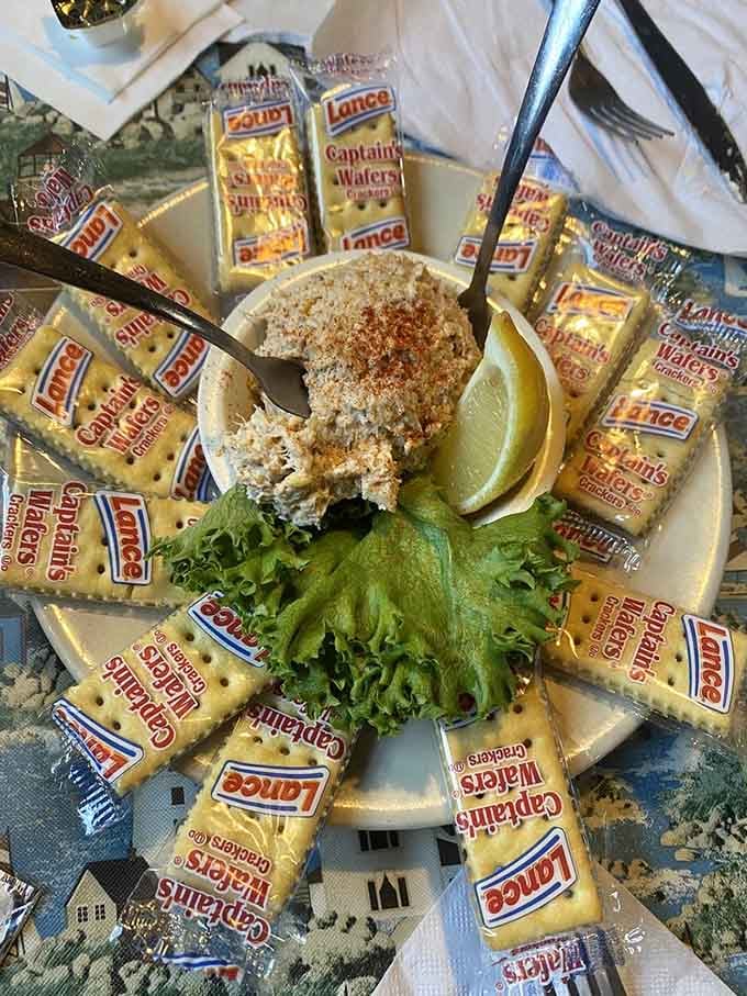 Crab dip surrounded by crackers like a delicious sunburst of coastal flavor and indulgence.