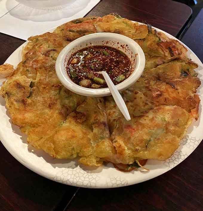 That golden seafood pancake is crispy, savory perfection that makes you wonder why pancakes are only breakfast food.