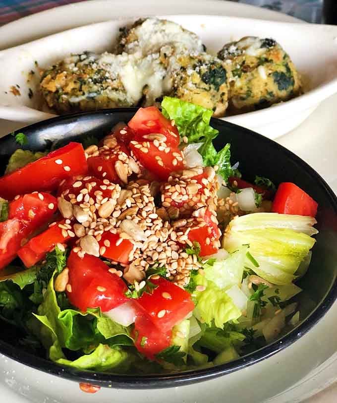 Stuffed mushrooms paired with a colorful salad create the kind of meal that makes you feel virtuous and satisfied simultaneously.