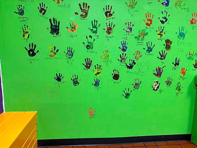 Every colorful handprint tells a story of celebration, turning a simple wall into a rainbow testament of happy moments.