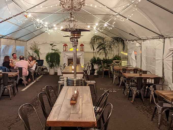 The tent seating area where strangers become friends united by their collective decision to eat cake instead of vegetables tonight.
