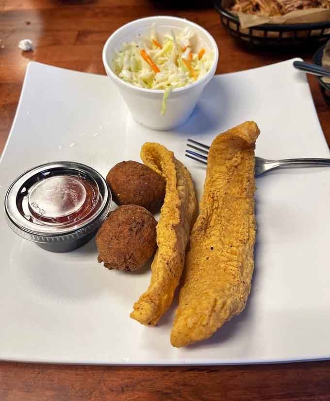 Golden fried catfish with hush puppies proves this menu goes beyond barbecue into Southern comfort territory.