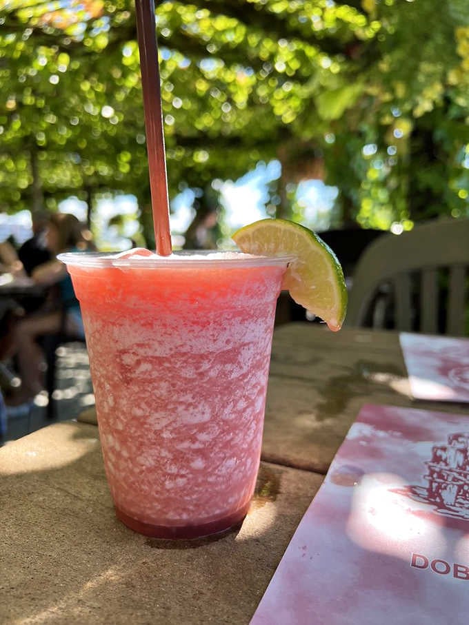 A frozen rum runner that's basically summer in a glass, perfect for sipping while watching the boats.