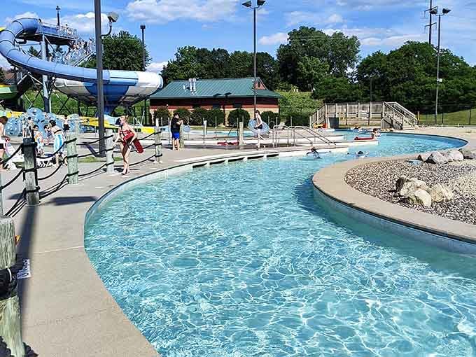 The lazy river winds through the park like a liquid highway designed specifically for people who've mastered relaxation.