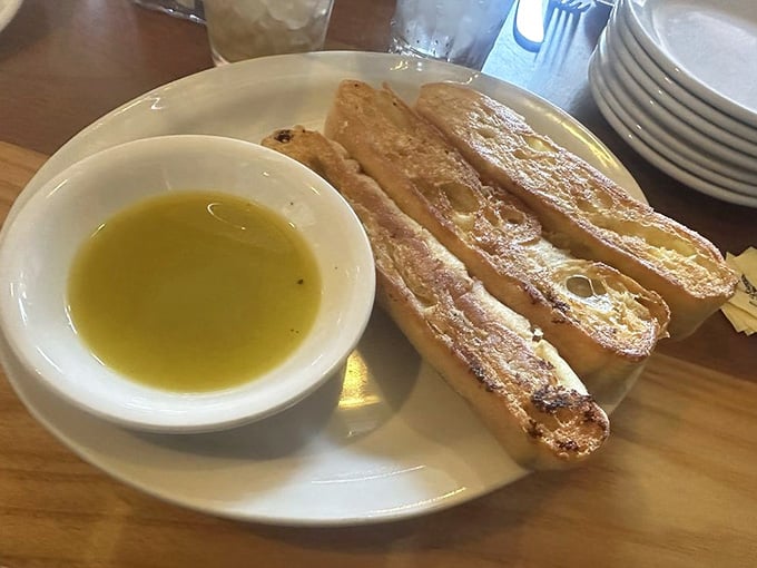 Warm focaccia served with herb-infused olive oil, the kind of starter that makes you reconsider your entire meal plan.