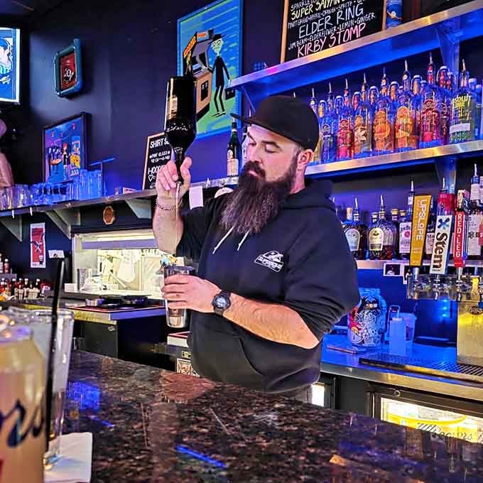 Your bartender pours drinks with the precision of someone who respects both craft cocktails and classic gaming.