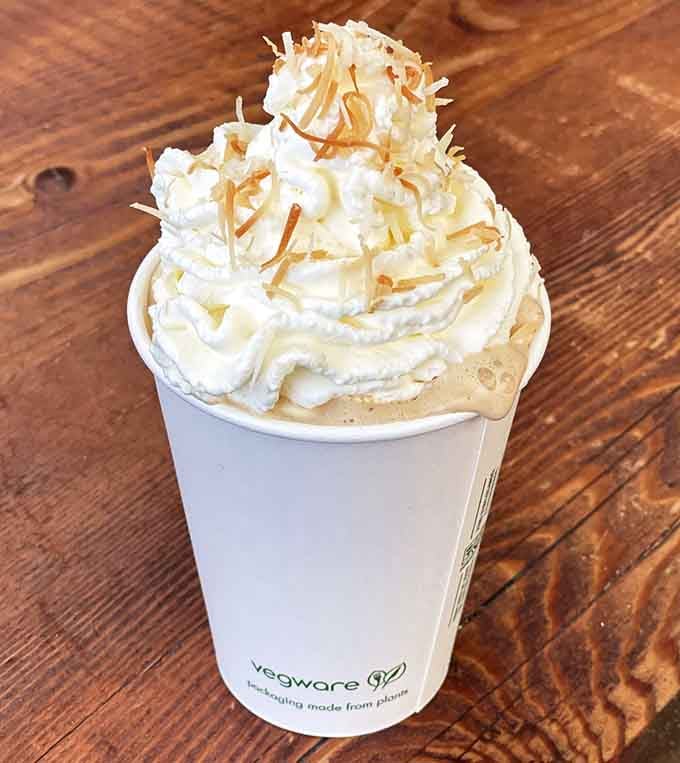 That mountain of whipped cream isn't just generous, it's practically architectural, and we're absolutely here for every glorious bite.