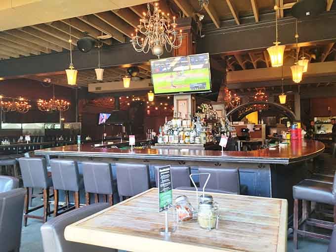 The bar stretches long and welcoming, perfect for solo diners or groups plotting their pizza strategy together.