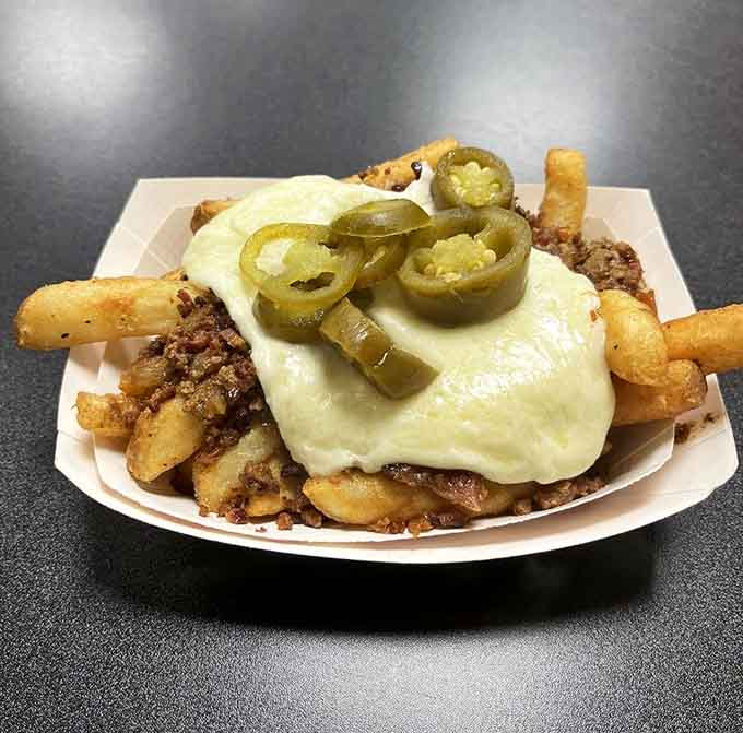 Crispy fries buried under a mountain of melted cheese and crowned with jalape&ntilde;os, because sometimes restraint is highly overrated in the best way.