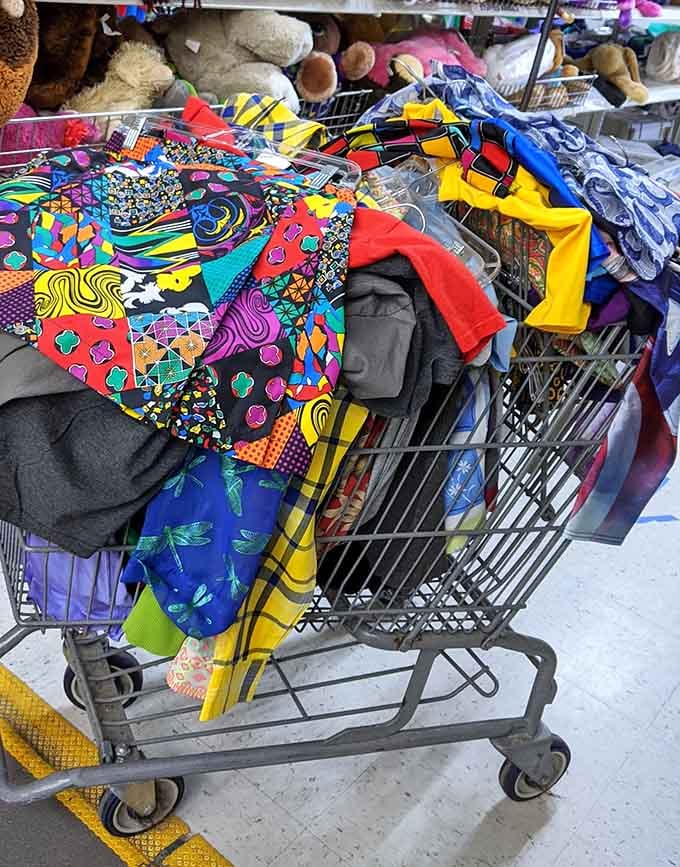 Cart overflowing with colorful finds represents the beautiful chaos of successful thrift shopping done absolutely right today.
