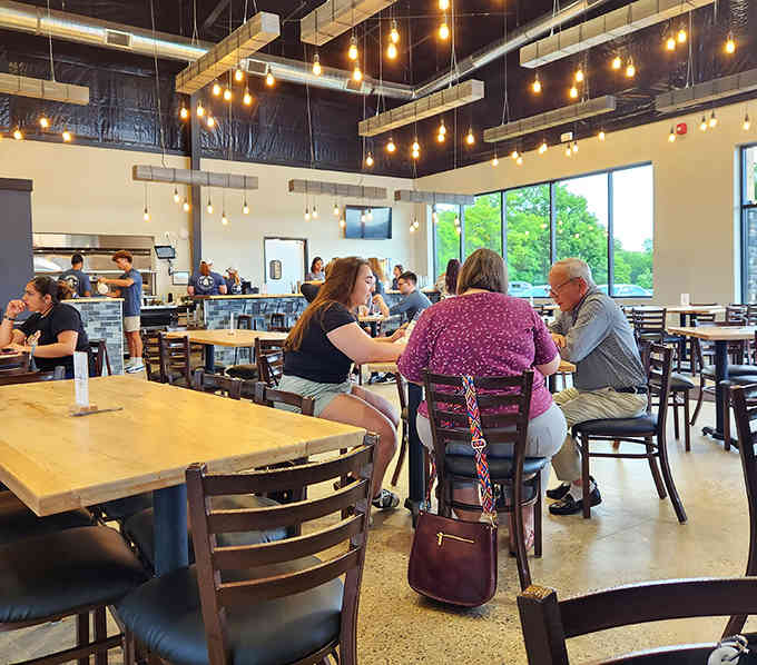 Real families enjoying real meals in a space designed for actual human behavior, not museum-quality silence.