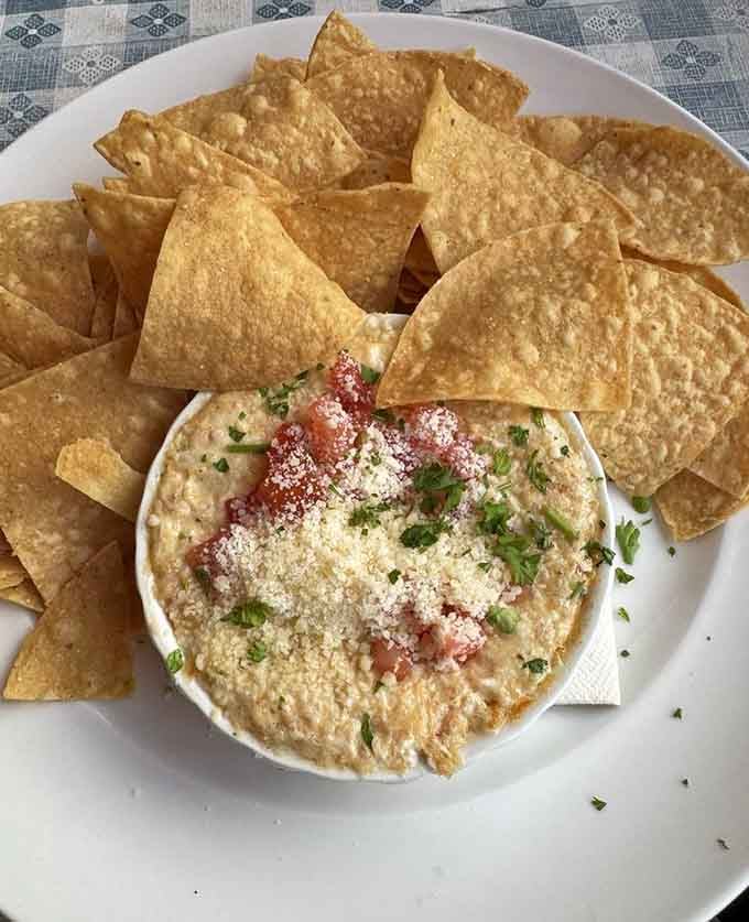Crab dip surrounded by chips is the kind of appetizer that starts friendships and ends diets simultaneously.