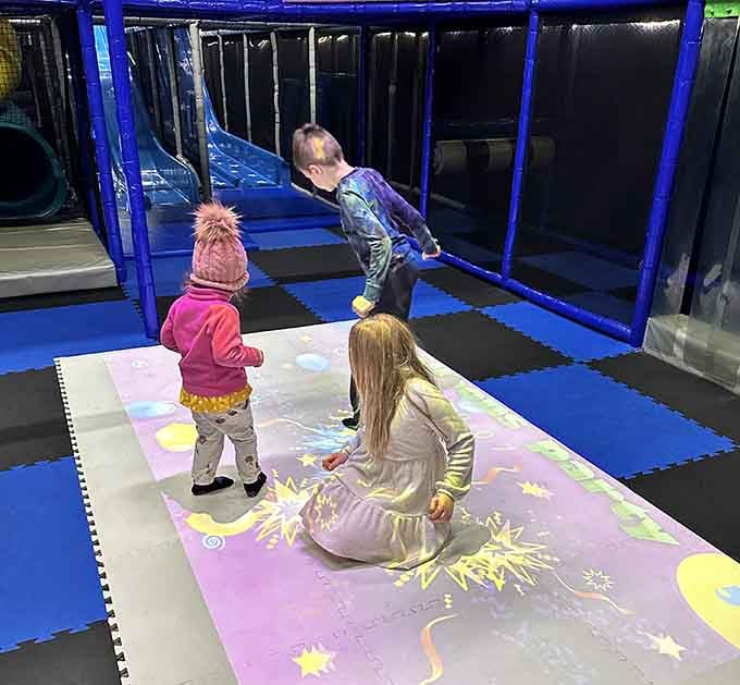 Three kids, one trampoline, pure joy captured mid-bounce as gravity temporarily loses its grip on childhood.
