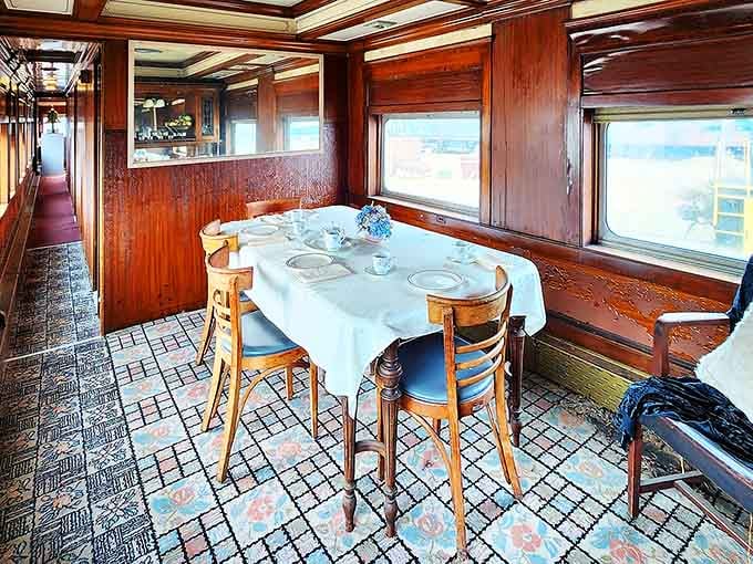 Polished wood paneling and crisp linens transform this dining car into a rolling restaurant worthy of Agatha Christie.