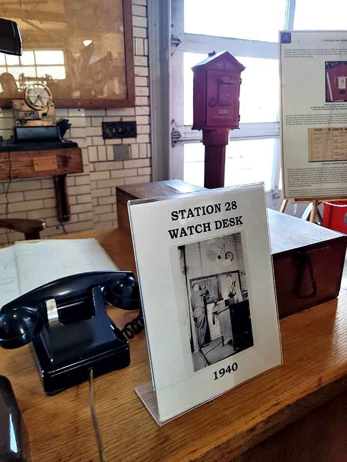 The Station 28 Watch Desk from 1940 sits ready, rotary phone waiting for calls that modern firefighters answer digitally.