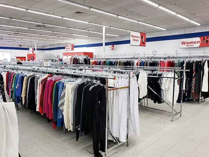 Women's clothing racks stretch endlessly, offering second chances for garments that still have stories to tell.