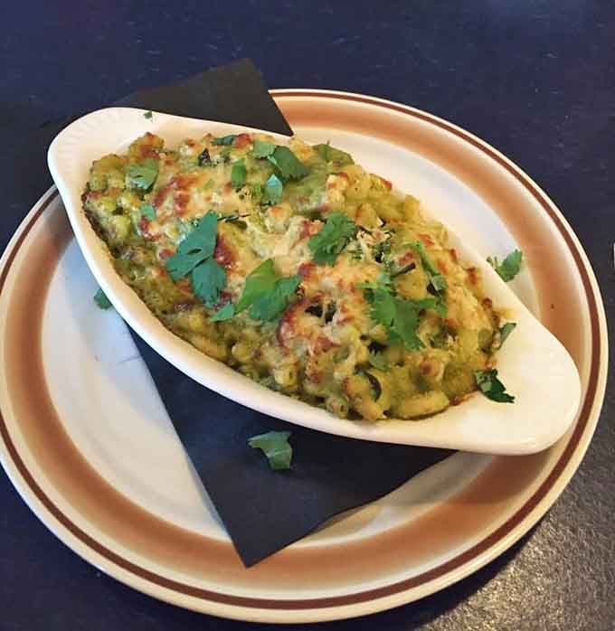 Chile mac and cheese served in a boat because regular bowls apparently weren't ready for this level of comfort.