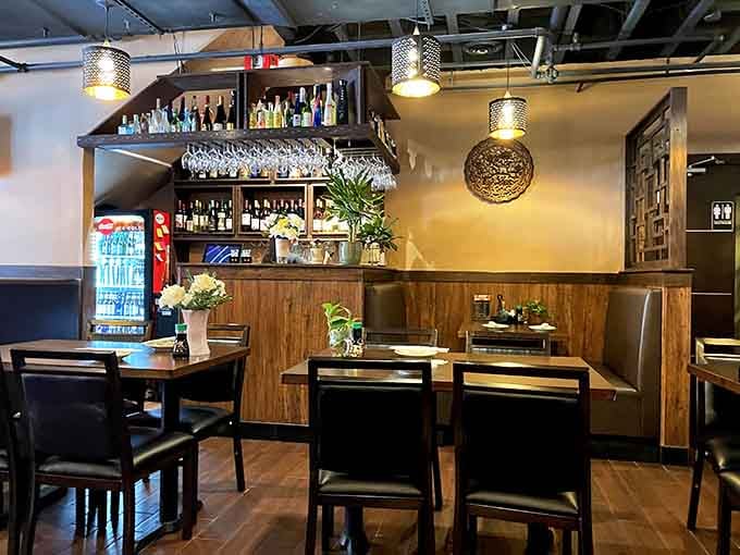 Warm wood, soft lighting, and a bar stocked for stories&mdash;this cozy corner feels like dinner and a quiet escape in one.