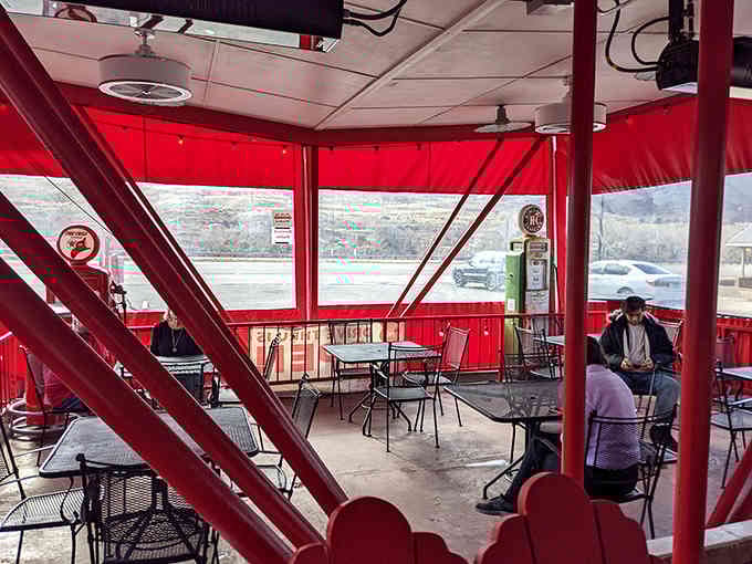 Real people enjoying real food under that distinctive red canopy, creating the kind of memories that last longer than fancy restaurant receipts.