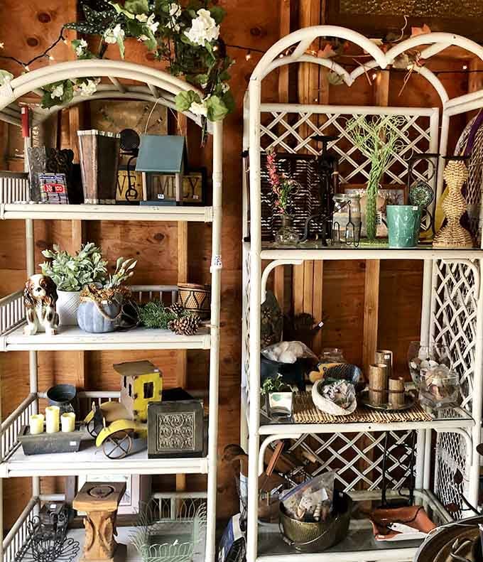 White lattice shelving frames an artful arrangement of vintage finds that would make any decorator swoon with envy.