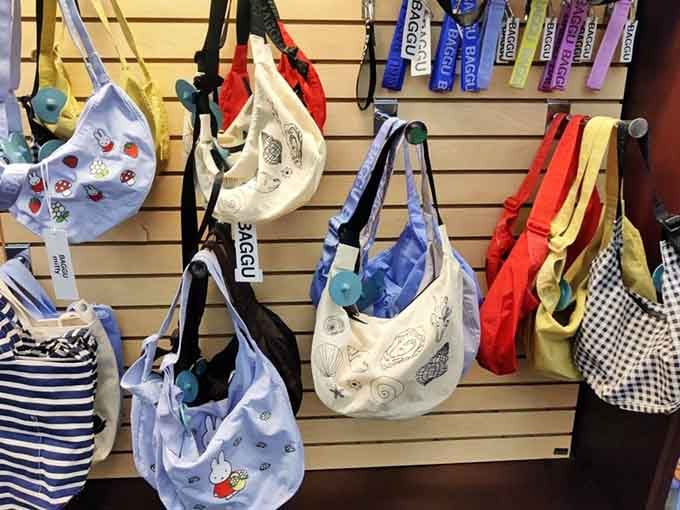 Tote bags in every pattern imaginable, because carrying books in your arms went out with card catalogs.