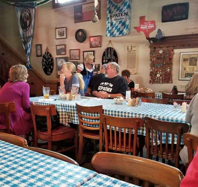 The communal tables and Bavarian flags overhead create the kind of convivial atmosphere where strangers become friends over sausages.