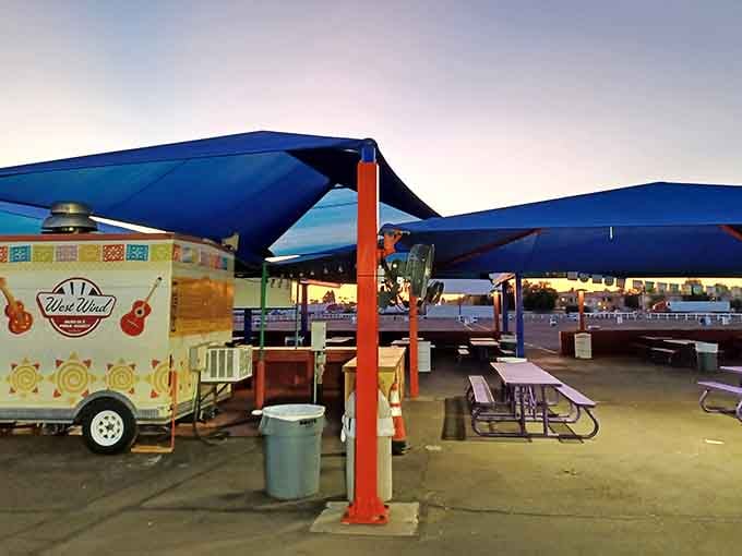 Blue canopies shelter picnic tables where families can dine before the stars come out overhead.
