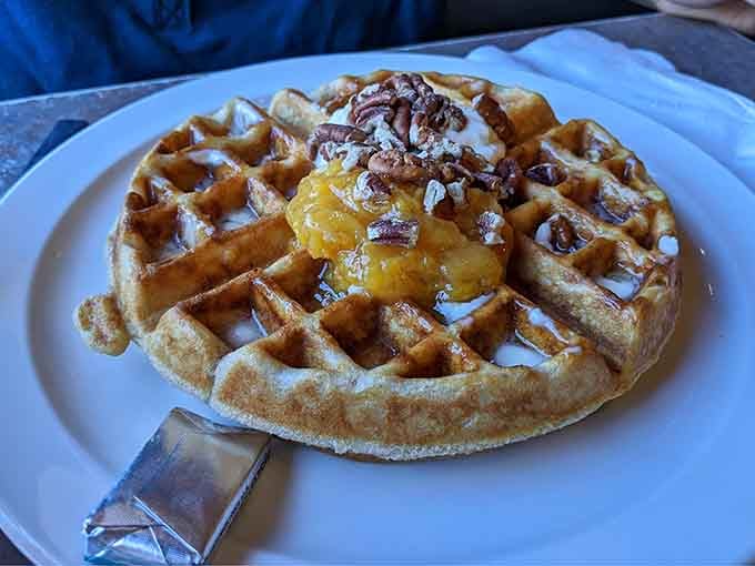 Golden, crispy waffles topped with fruit and pecans – breakfast never looked so photogenic or tasted so divine.