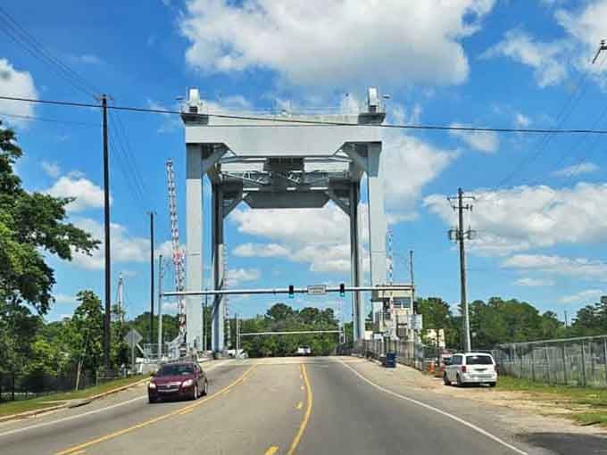 This drawbridge connects communities across the water, lifting skyward like a mechanical ballet when boats pass.