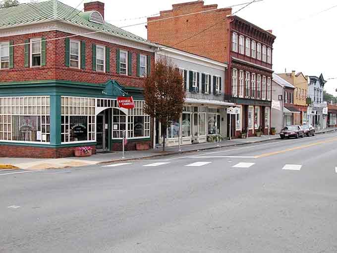Small-town storefronts in warm brick tones create the kind of downtown where everyone becomes a regular customer quickly.