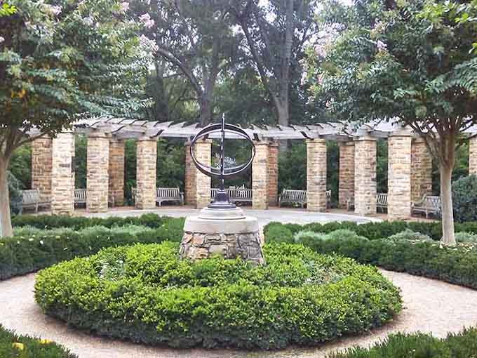 Formal gardens frame a sculptural centerpiece with geometric precision, proving that nature and design make wonderful partners when done right.