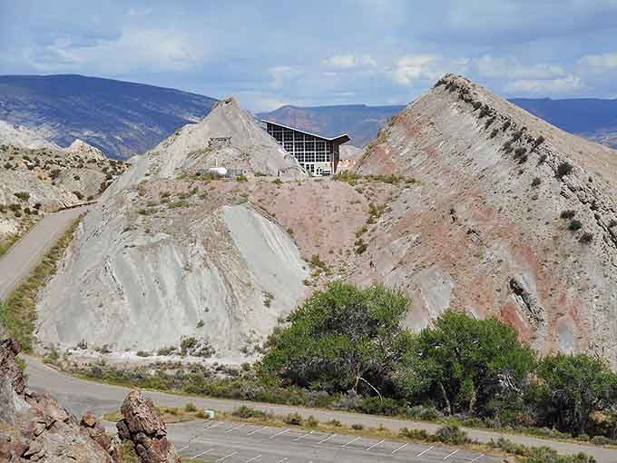 These towering tailings piles stand as monuments to Colorado's mining past, dramatic against the desert sky.