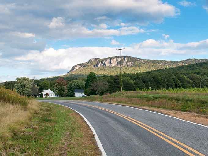 That dramatic cliff rising above the farmland looks like nature's own drive-in movie screen waiting for showtime.