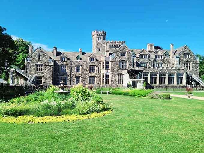 Massive stonework and multiple wings spread across the landscape like a small village designed by one very ambitious architect.