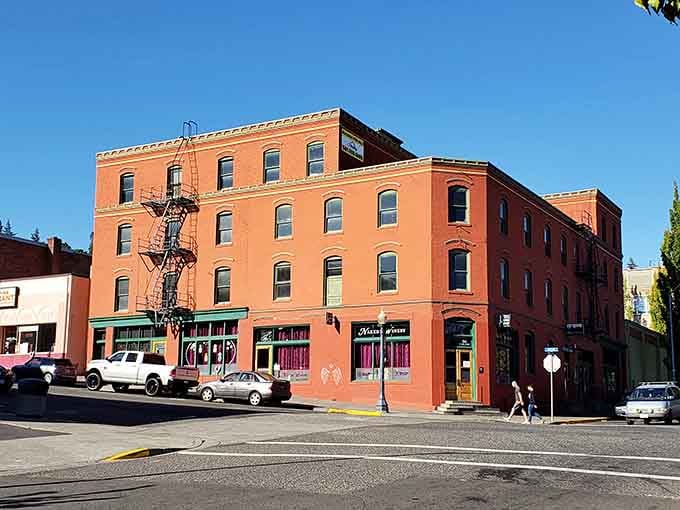 This coral-colored corner building radiates warmth and character, inviting you to step inside and explore its stories.